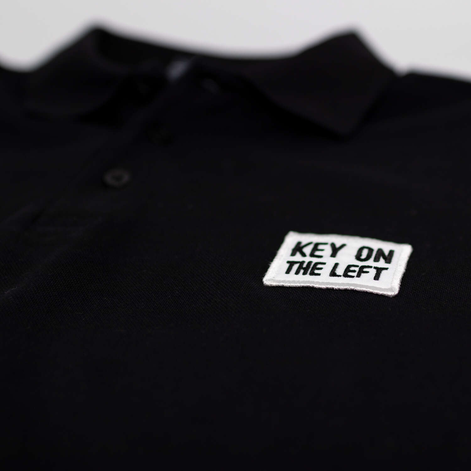 Polo Shirt Key on the left Schwarz - Driver's Collection - Elferspot Shop